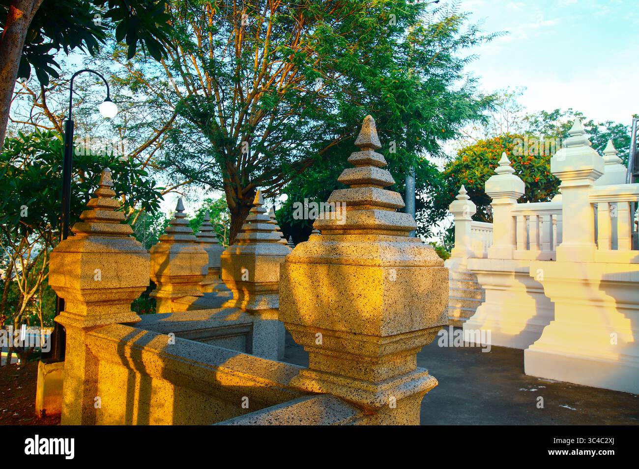 Traditional Thai temple architecture at sunset with intricate stone ...