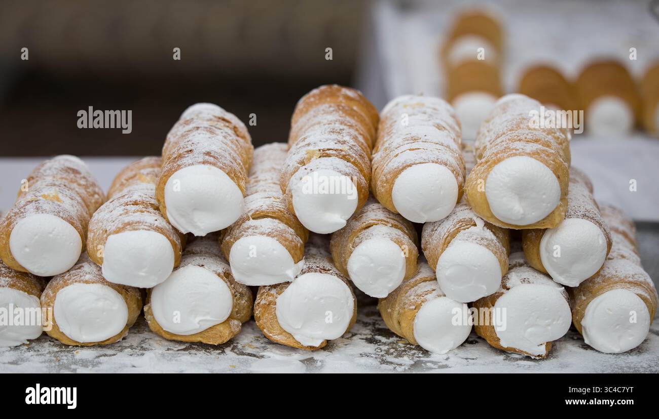 Traditional sicilian cannoli piled high with sweet ricotta filling and ...