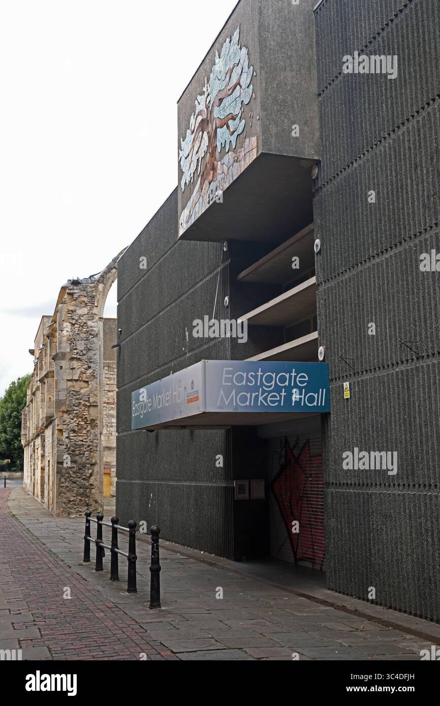 The modern entrance to Eastgate Market Hall and the remains of the 16th ...