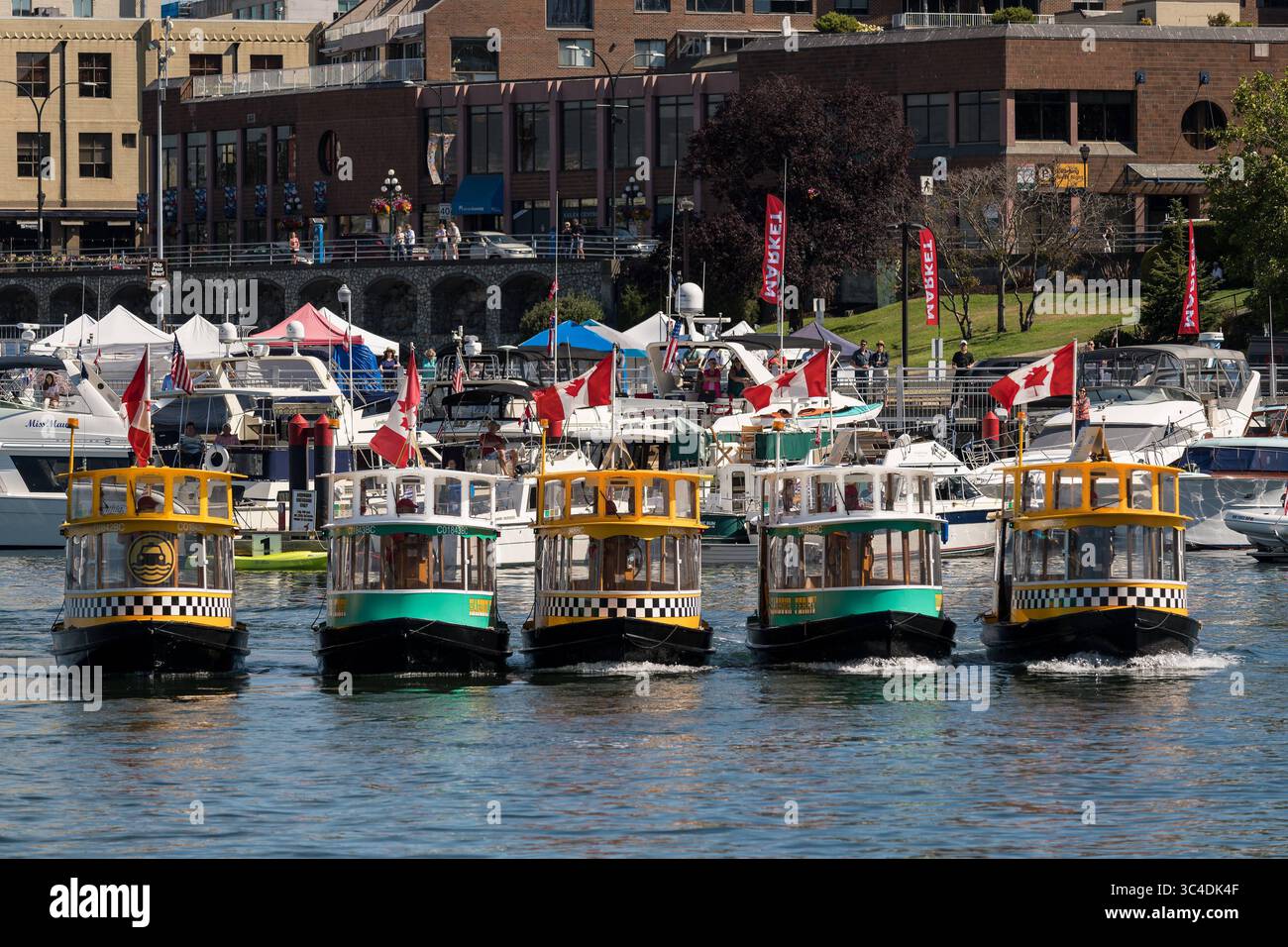 July 4, 2018 - Victoria, BC, Canada - Tiny harbor taxi ferries perform ...
