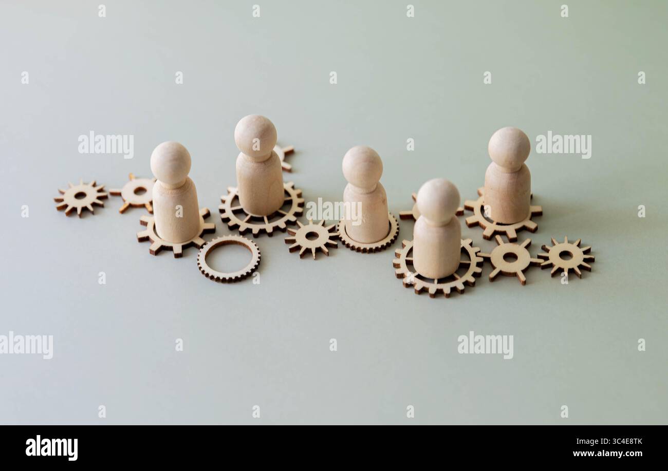 Wooden figures of people with metal gears close up. Hire personnel ...