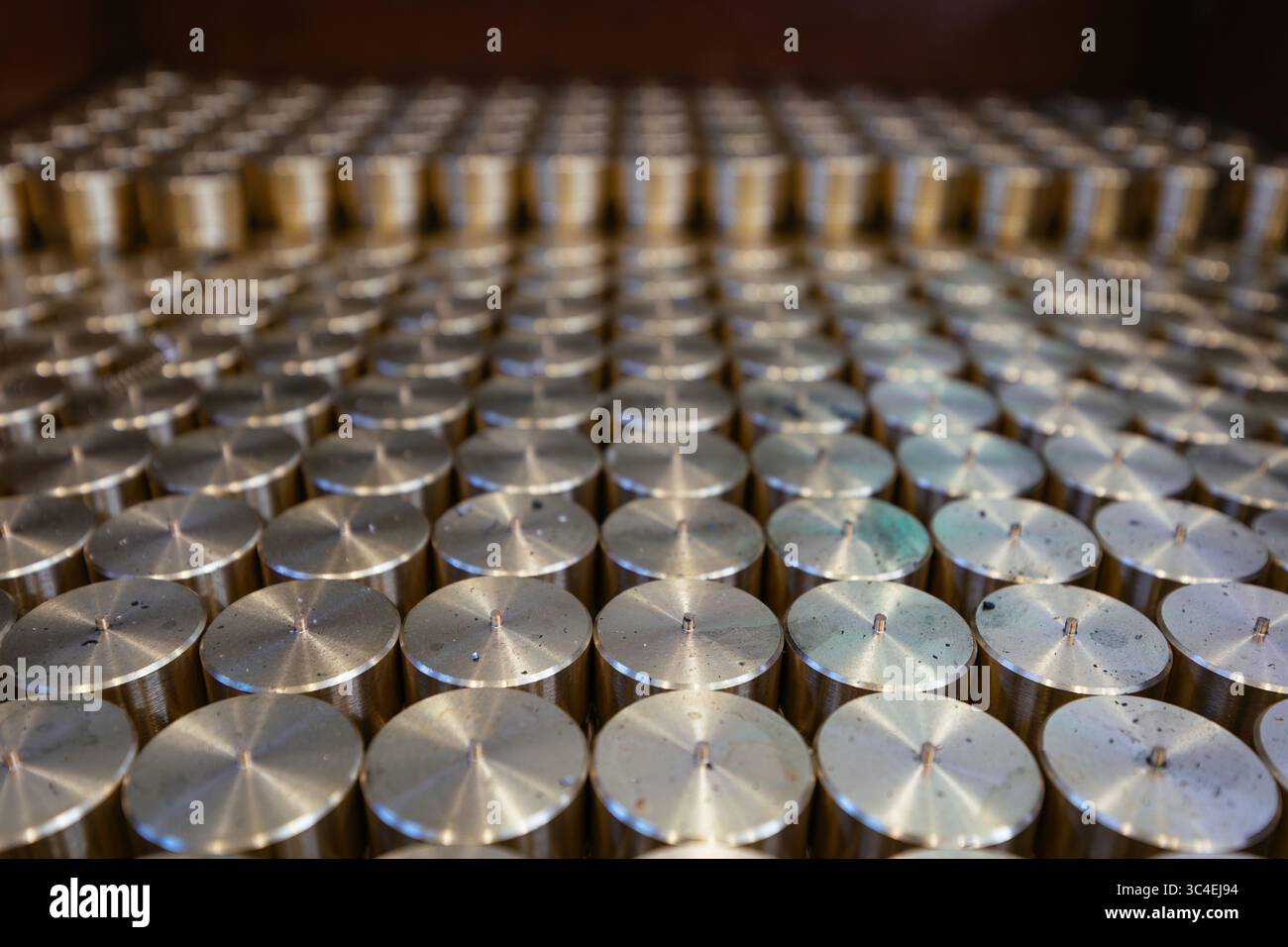 Cylindrical spare parts in rows, close up Stock Photo - Alamy