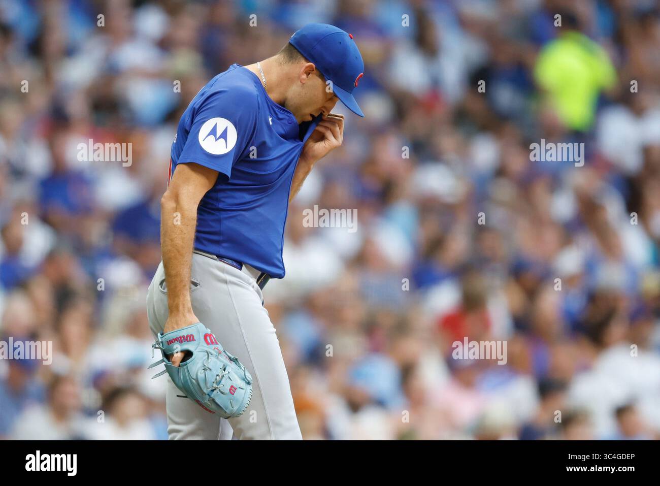 Chicago Cubs starting pitcher Matthew Boyd wipes his face during the ...