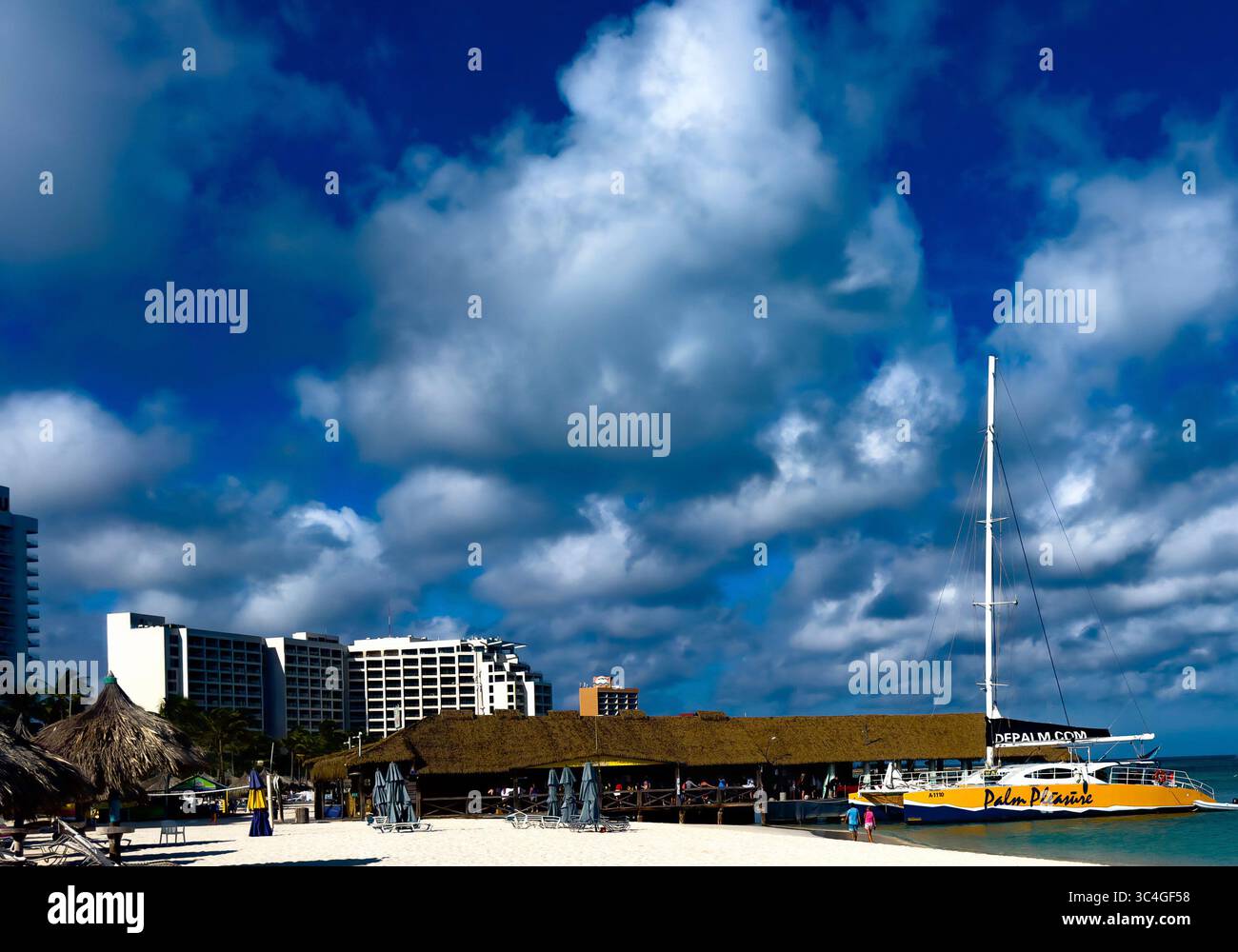 A catamaran tied up at a tropical island pier Stock Photo - Alamy