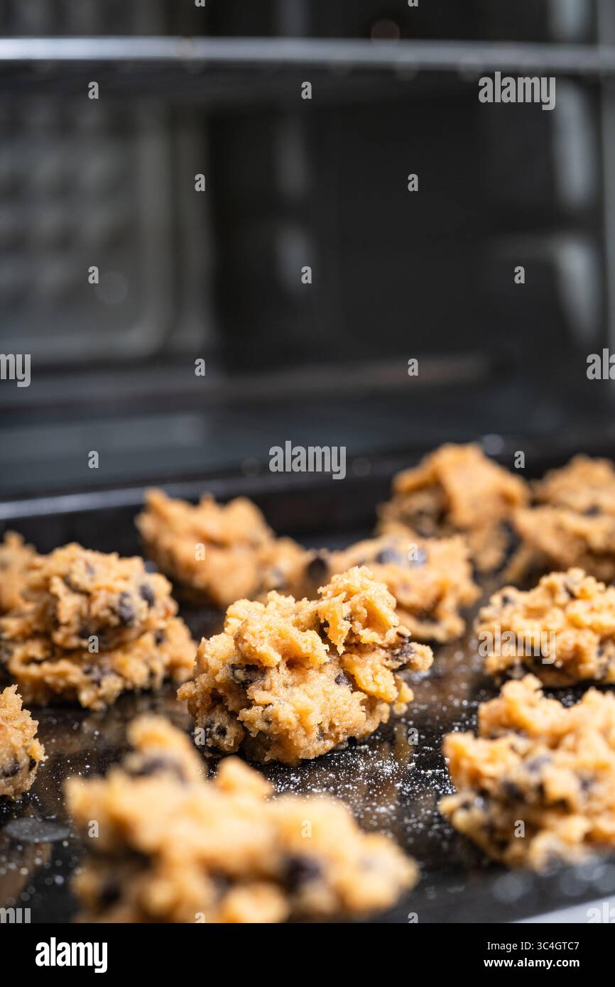 Chocolate chip cookies baking inside an oven, golden and rising. Ideal ...