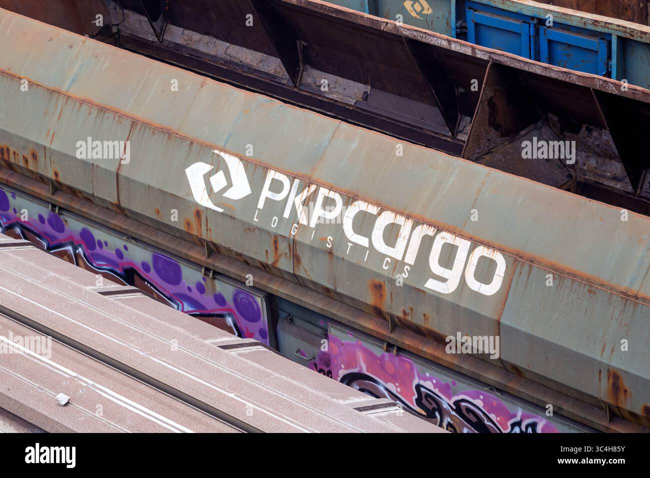 A container wagon bearing the logo of PKP Cargo is seen from a bridge ...