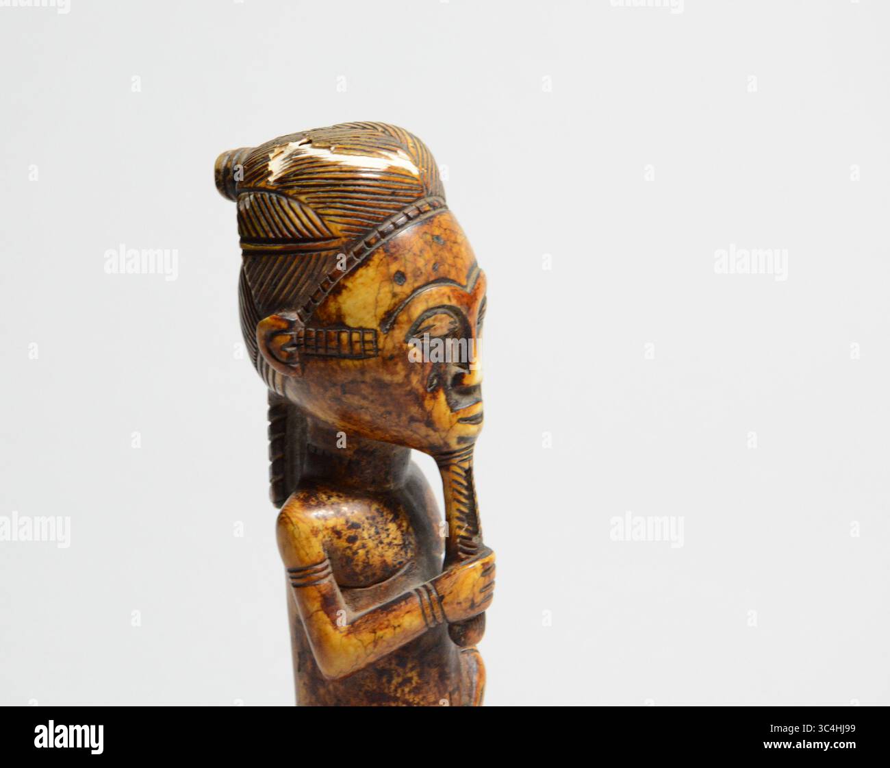 African Tribal Art Carved Ivory Seated Male Figure Stock Photo - Alamy