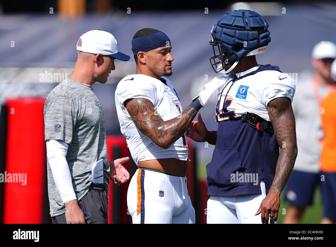 Denver Broncos tight end Evan Engram (1) greets wide receiver Courtland ...