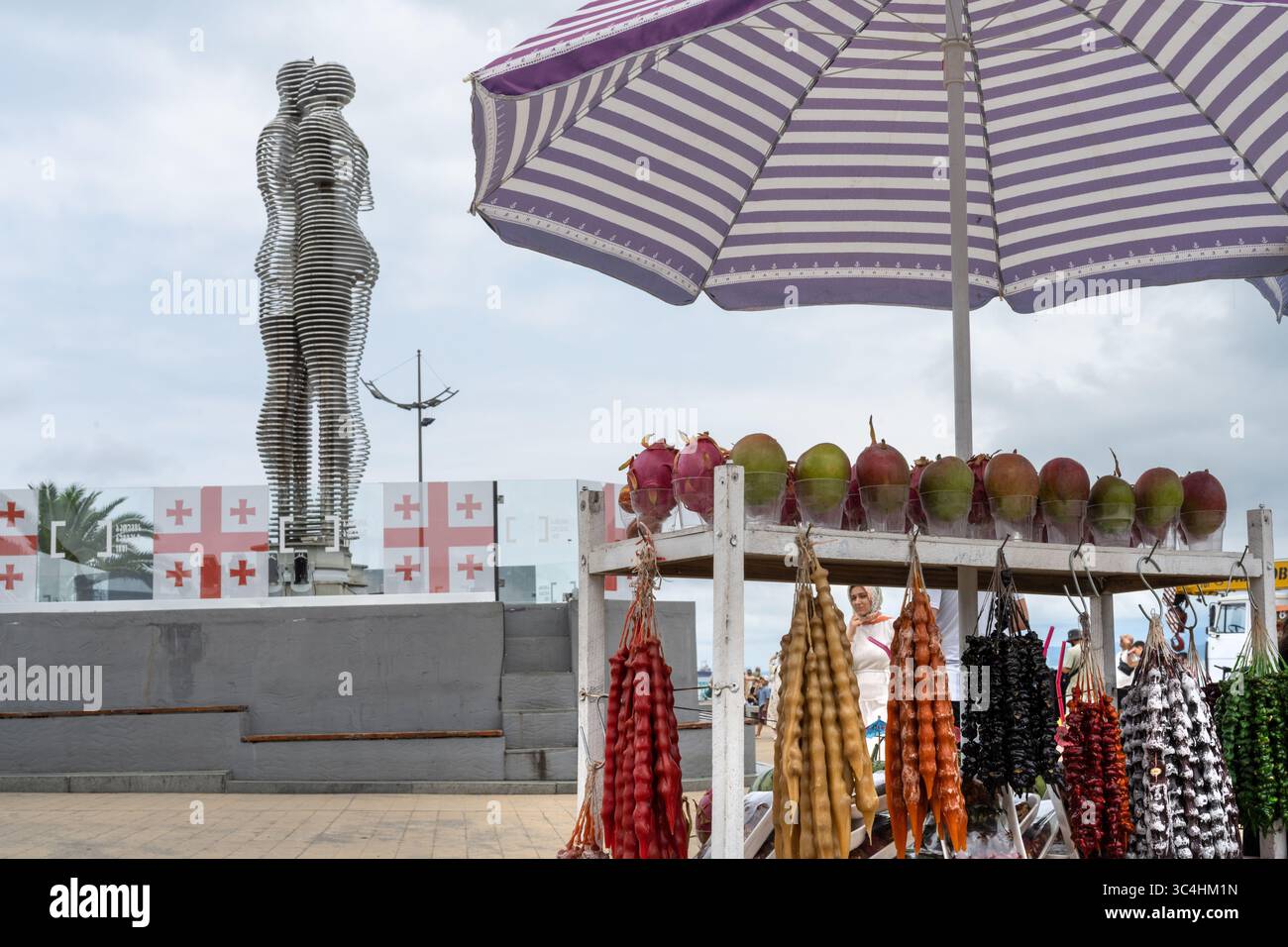 A street stall selling Churchkhela, a popular sweet snack made of nuts threaded on string and ...