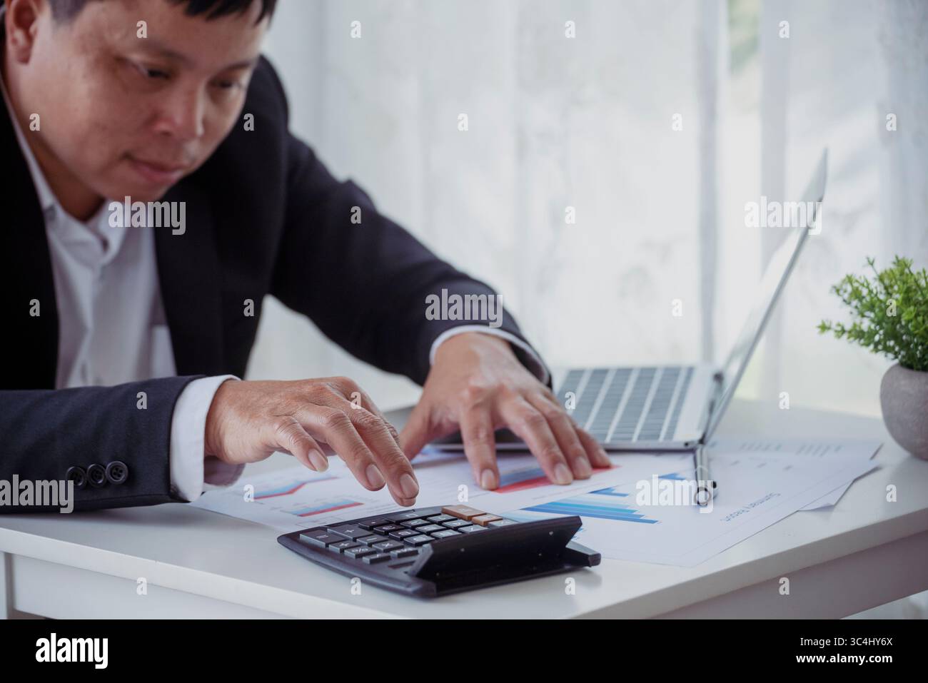 Asian businessman hands calculating number, graph, chart audit planning ...