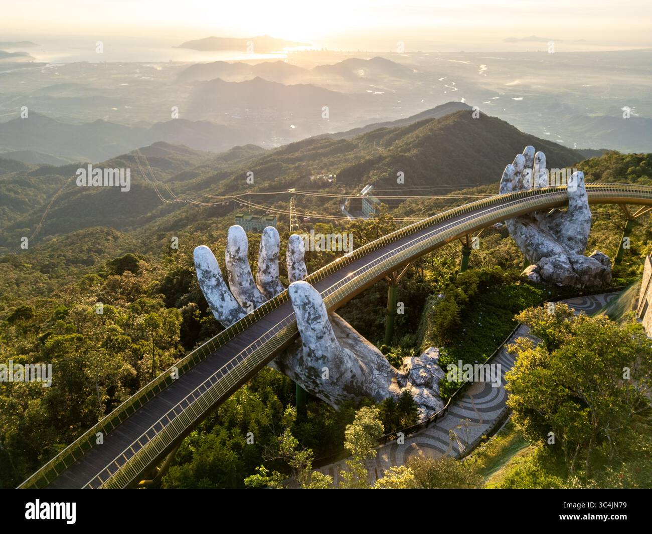 Aerial view of the iconic Golden Bridge, held by giant stone hands ...