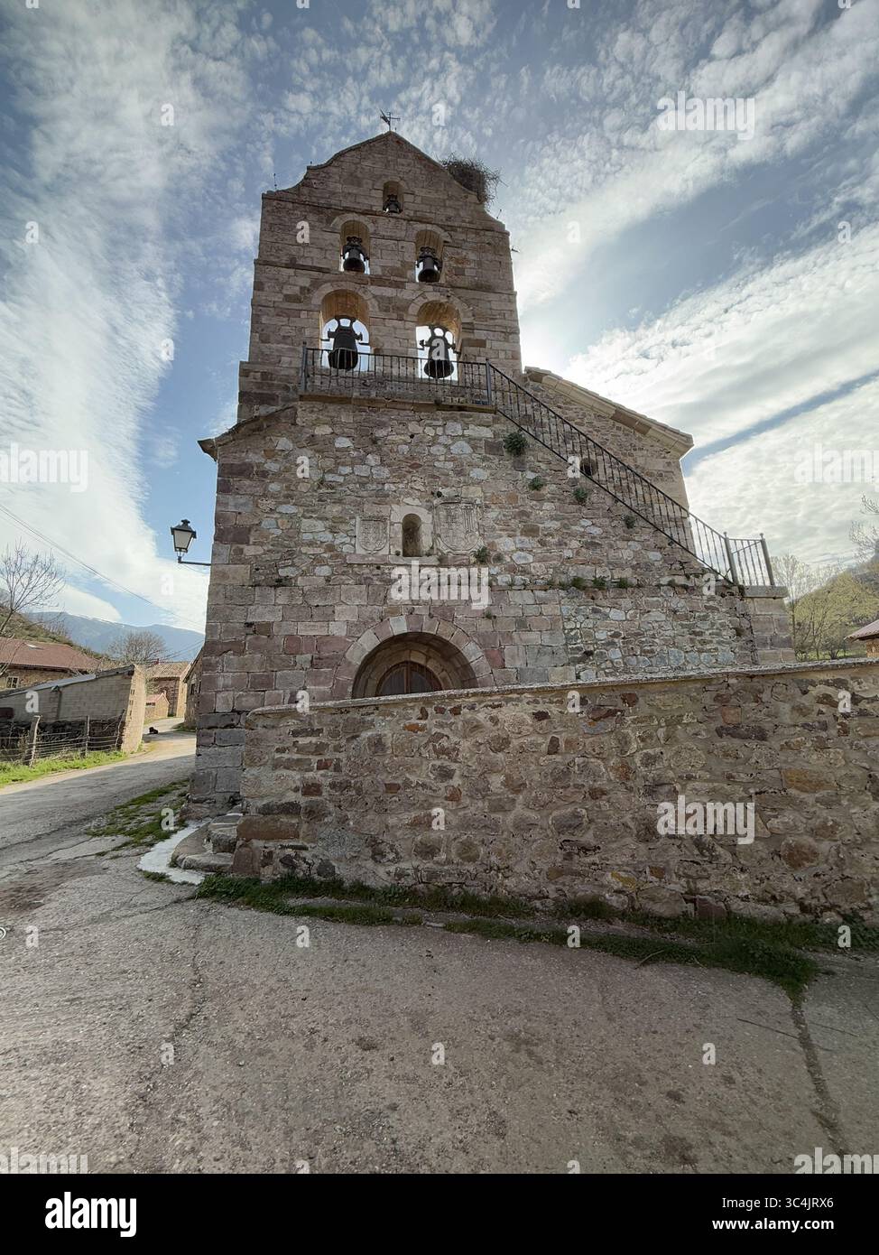 Old Romanesque-style church with stone walls, tiled roof, and bell ...