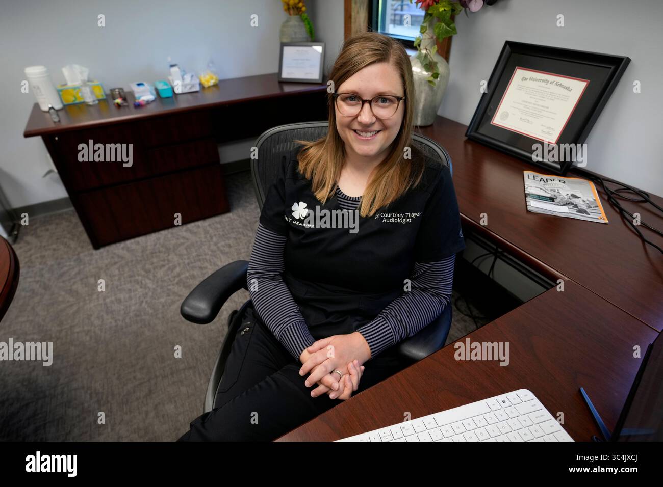 Audiologist Courtney Thayer sits at her desk in her office, Monday ...