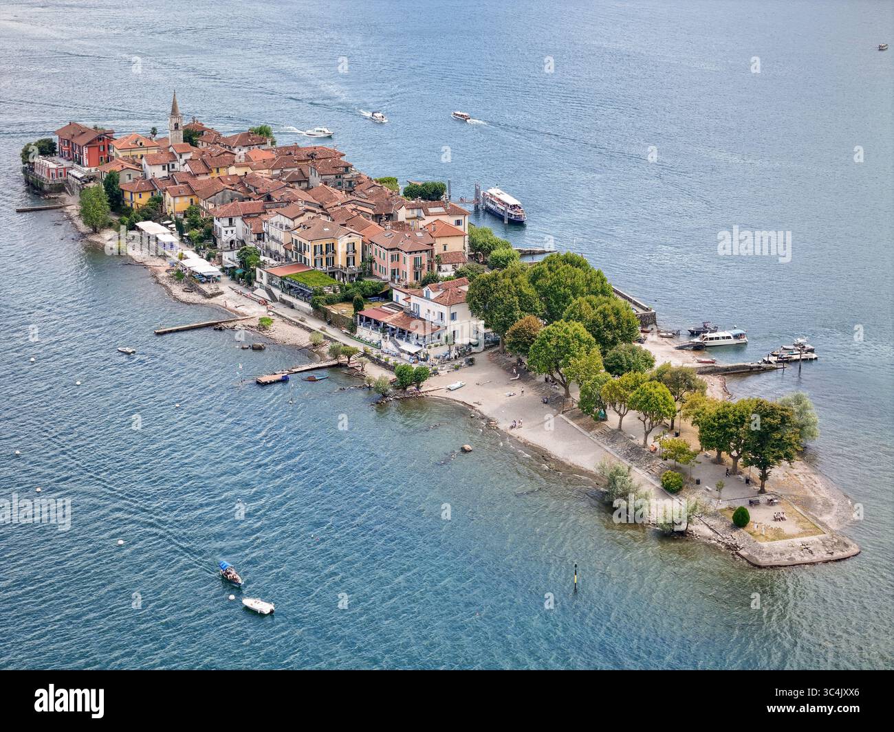 Aerial view of sun-drenched island village with terracotta roofs ...