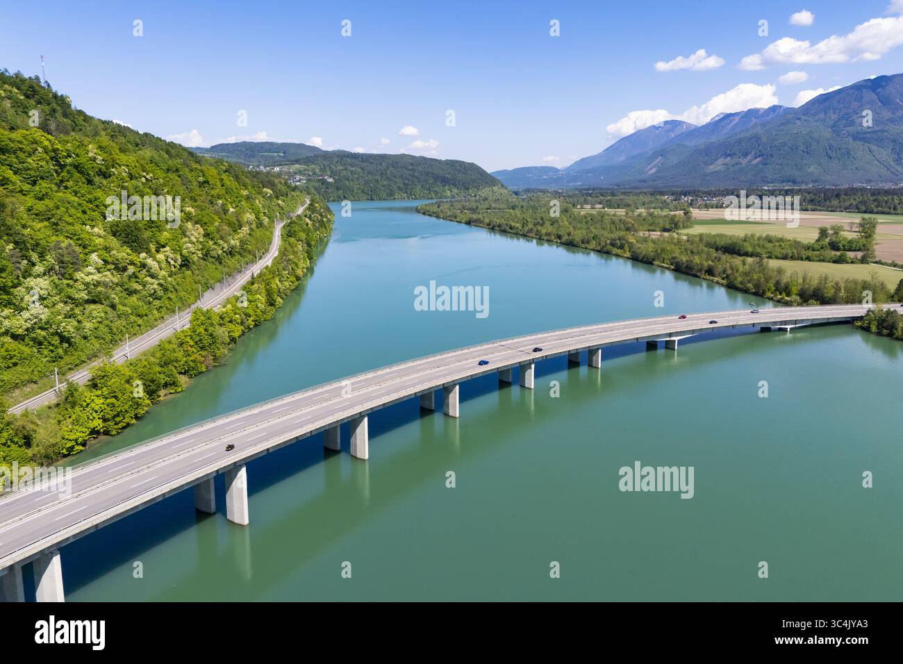 Aerial view of the Drava River flowing under a modern bridge ...