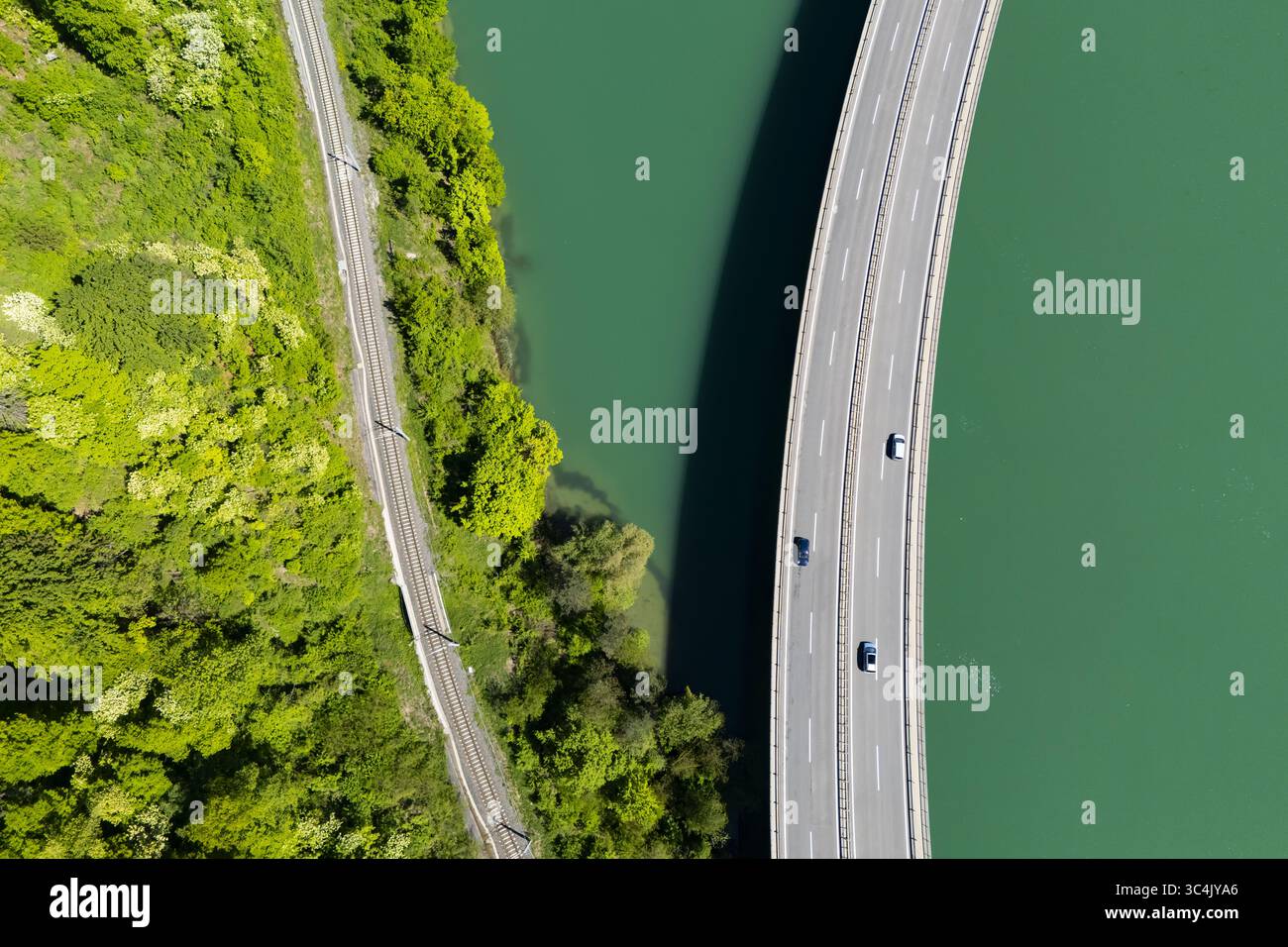 Aerial view of a bridge curving gracefully over the vivid turquoise ...