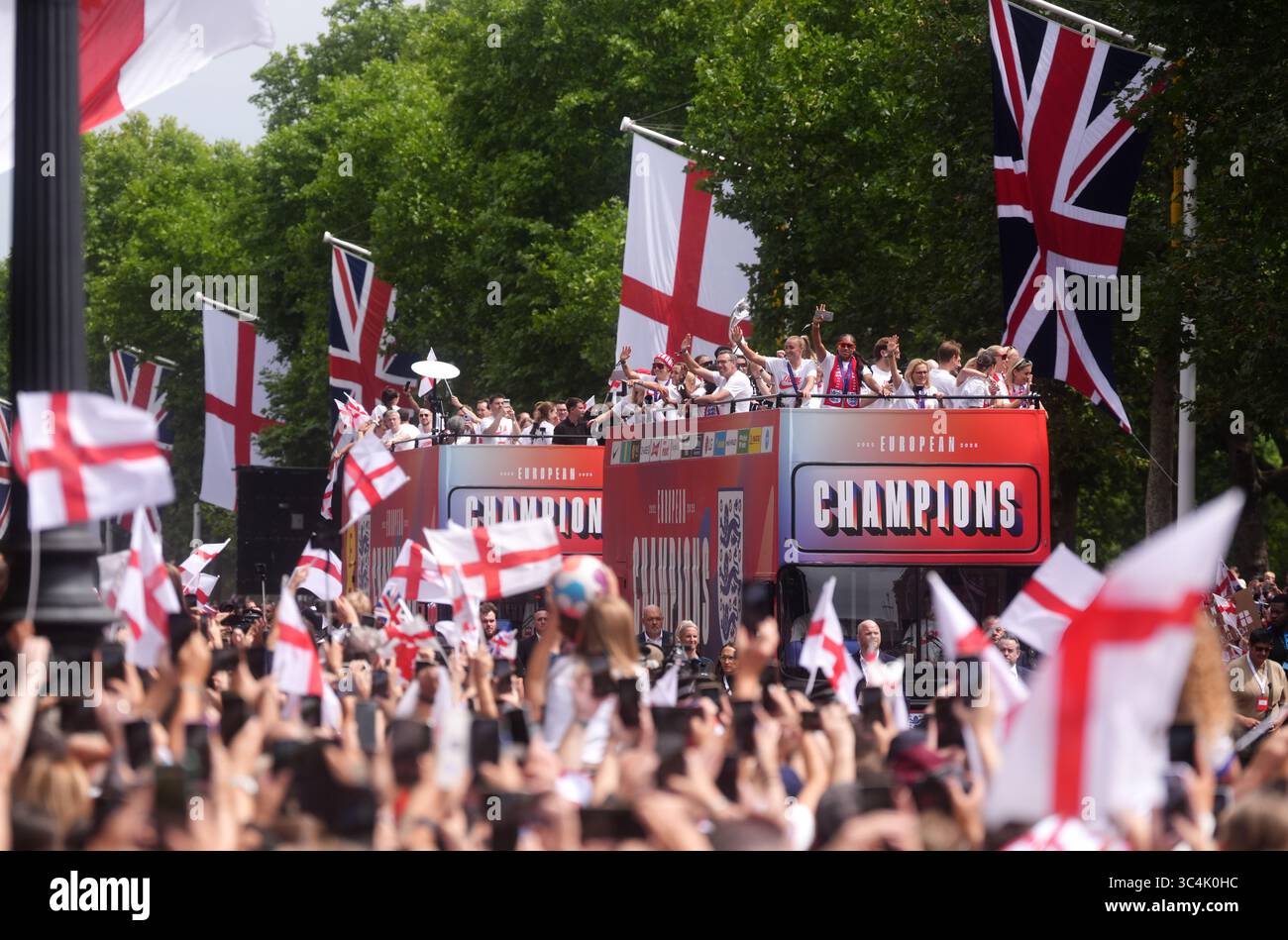 Buses carrying England players and staff make their way down the Mall ...