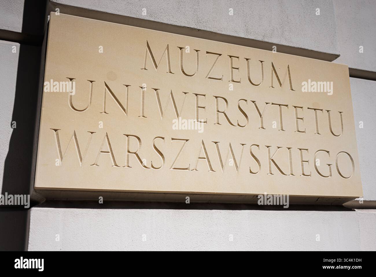 Engraved stone signboard on the wall of the Warsaw University Museum ...