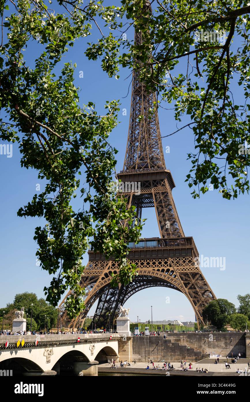 Eiffel Tower rising above green park trees summer Paris, France ...