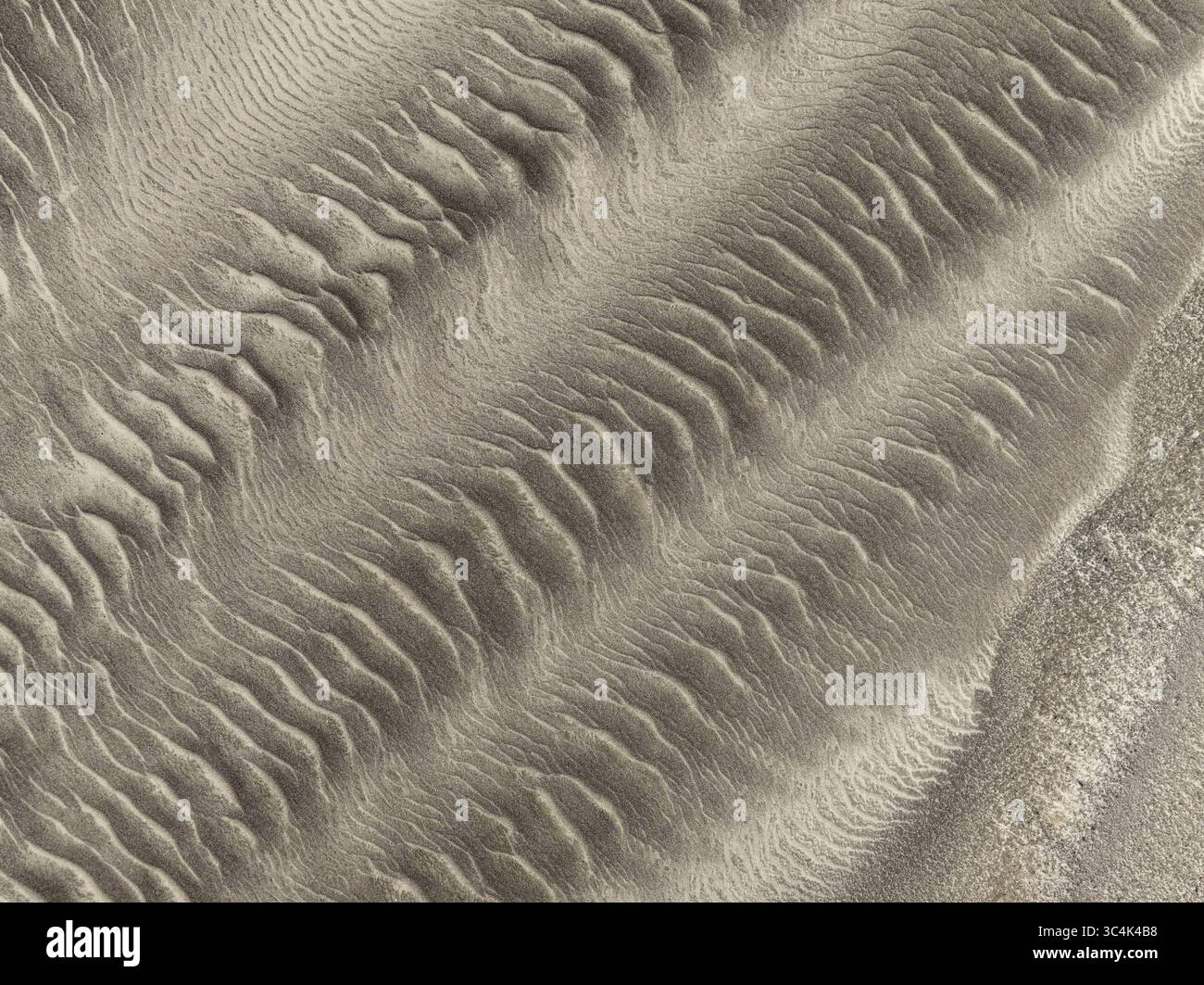 Aerial view of windswept dunes create a mesmerizing dance of light and ...