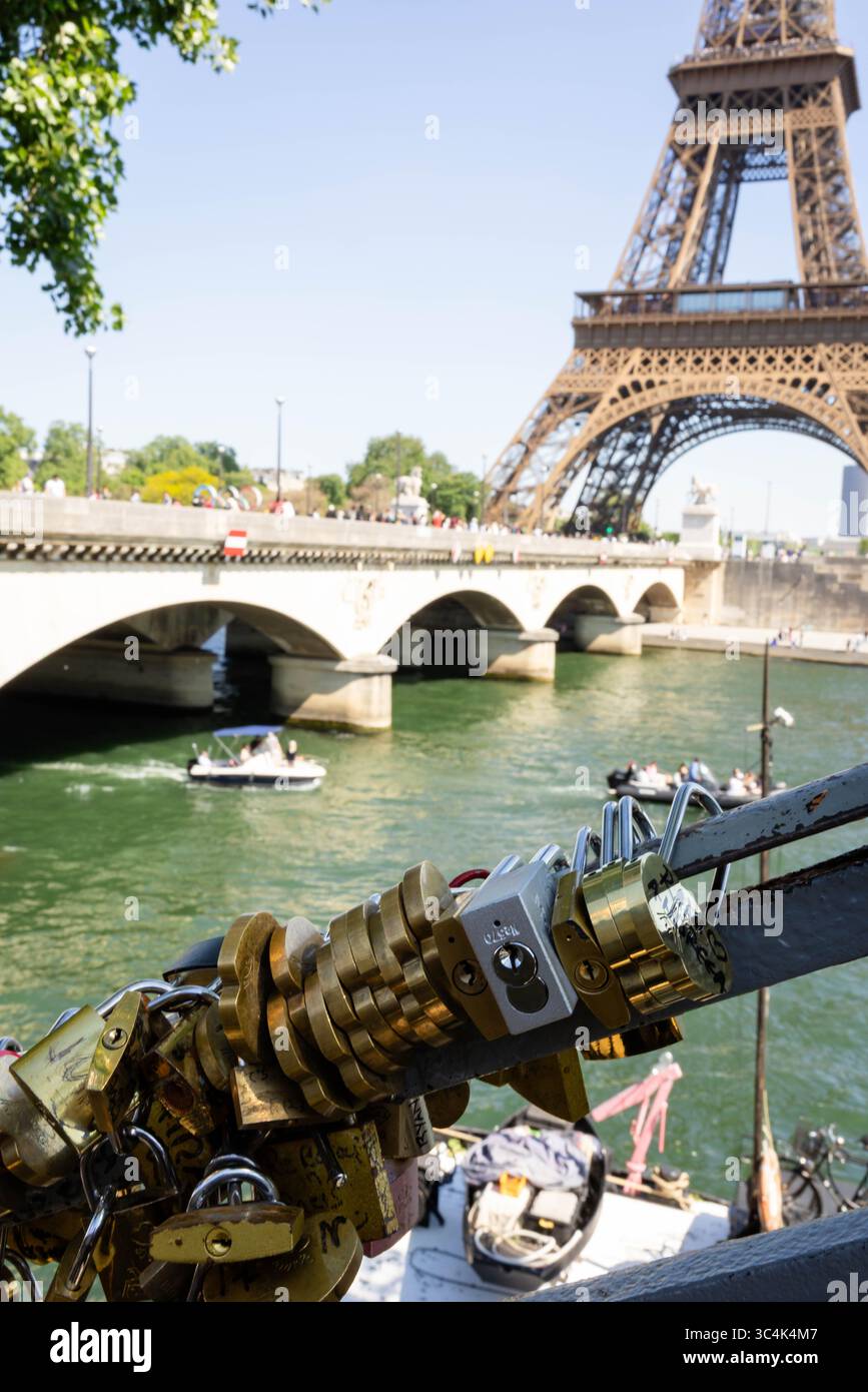 Love locks padlocks on Seine bridge railing with Eiffel Tower ...
