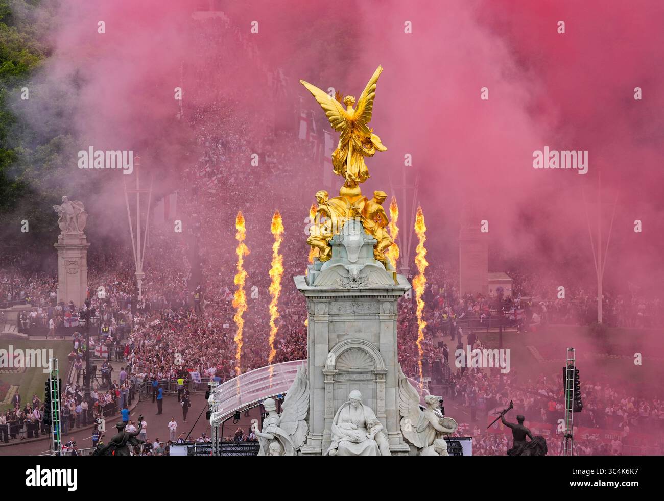 Fans gather and flares go off during a Homecoming Victory Parade on the ...