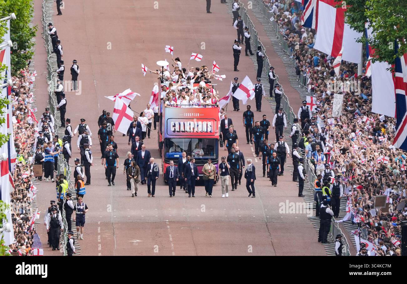 Buses carrying the England team make their way down the Mall during a ...