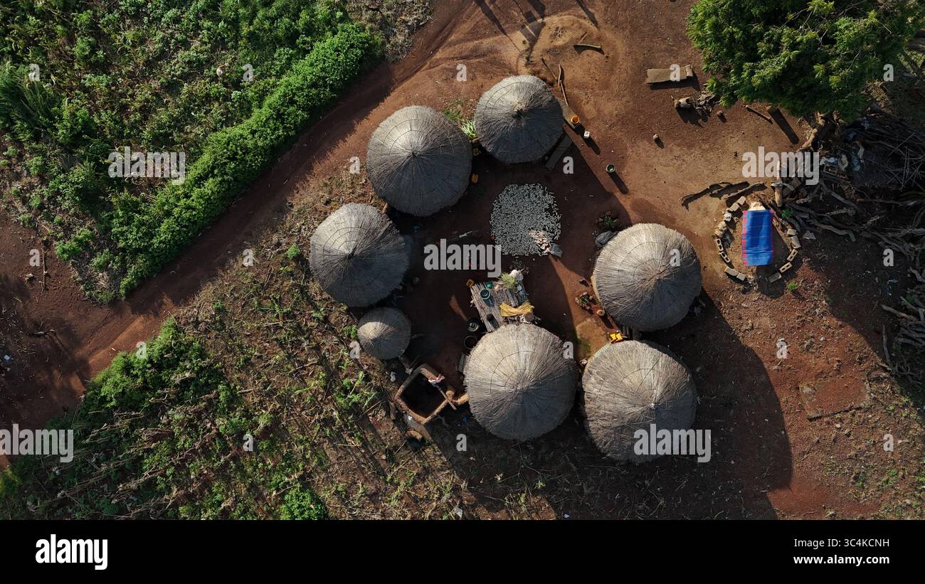 Aerial view of traditional thatched huts clustered together, a rustic ...