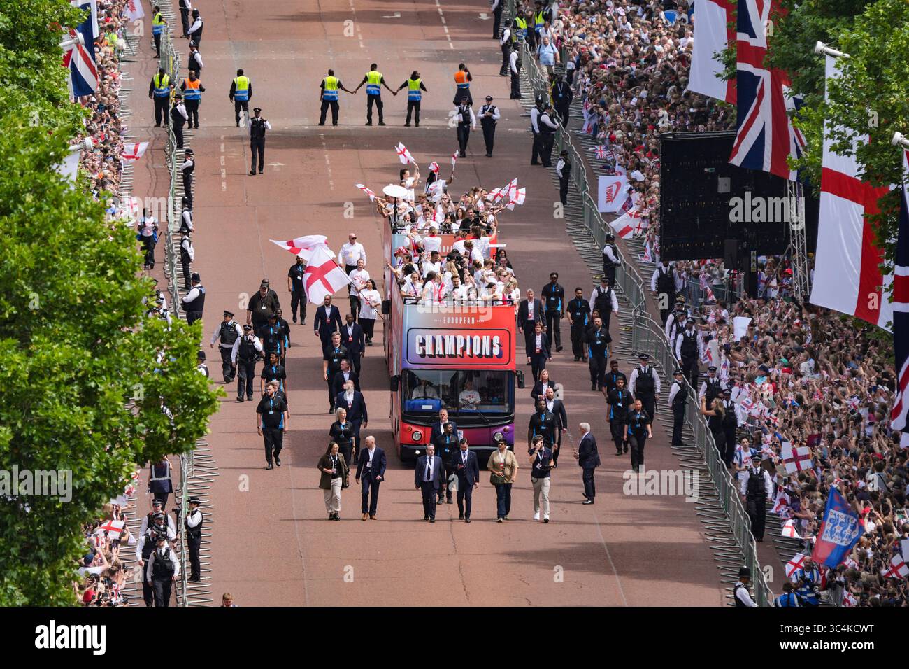 Buses carrying the England team make their way down the Mall during a ...