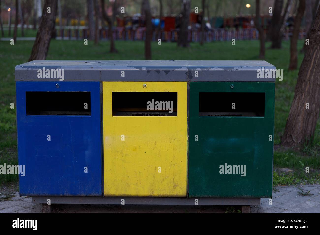 Colorful Recycling Bins in a Park Setting for Environmental ...
