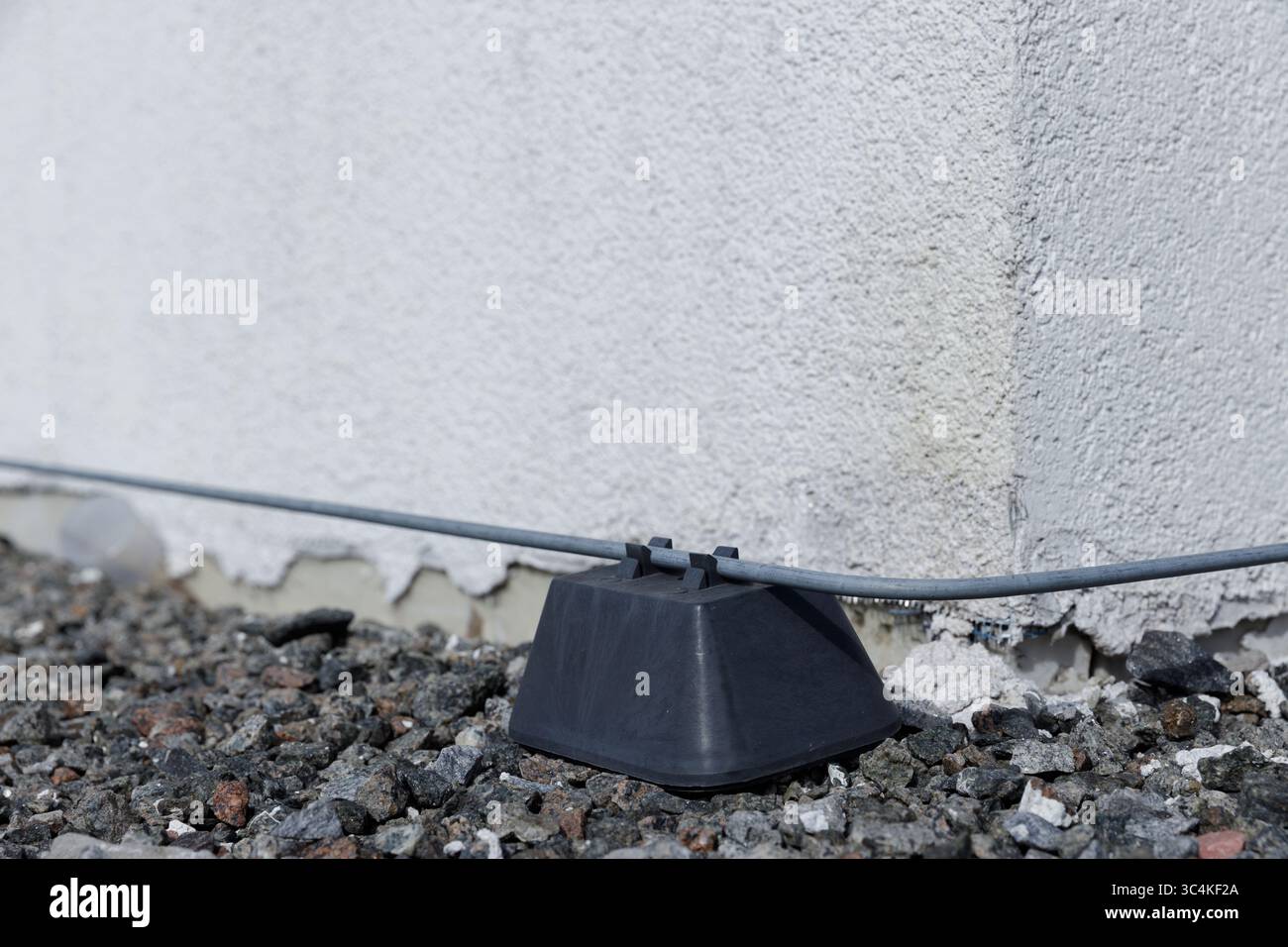 Detailed Close-Up of a Cable Holder Secured to a Wall, Embedded in ...