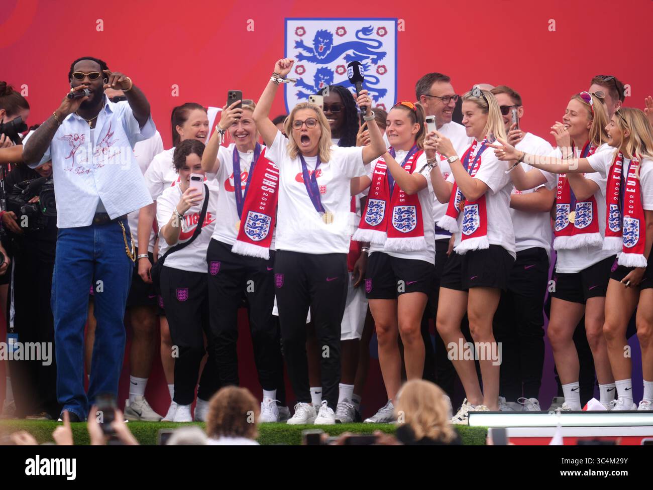 Burna Boy performs as England manager Sarina Wiegman and players ...