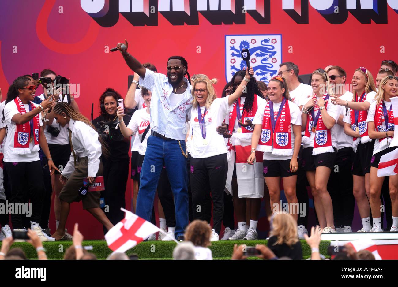 Burna Boy performs as England manager Sarina Wiegman and players ...