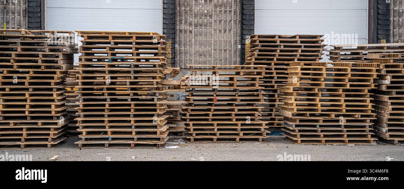 Stack of Wood pallets in front of loading dock Stock Photo - Alamy