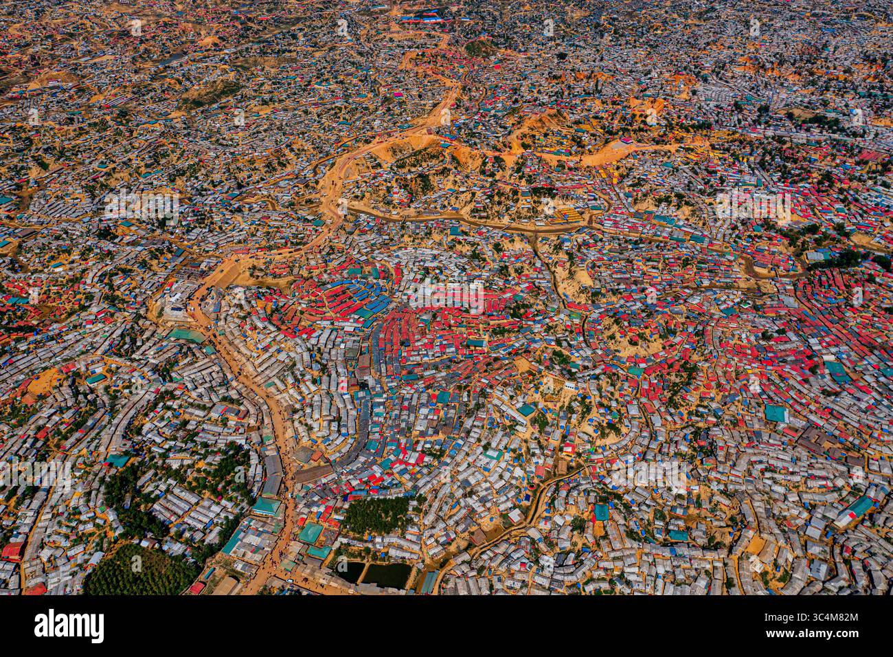 Aerial view of sprawling settlements with tightly packed structures and ...