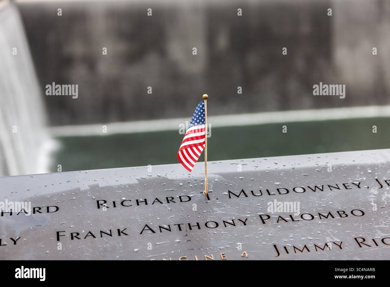 At Ground Zero, an American flag is planted in the engraving of the ...