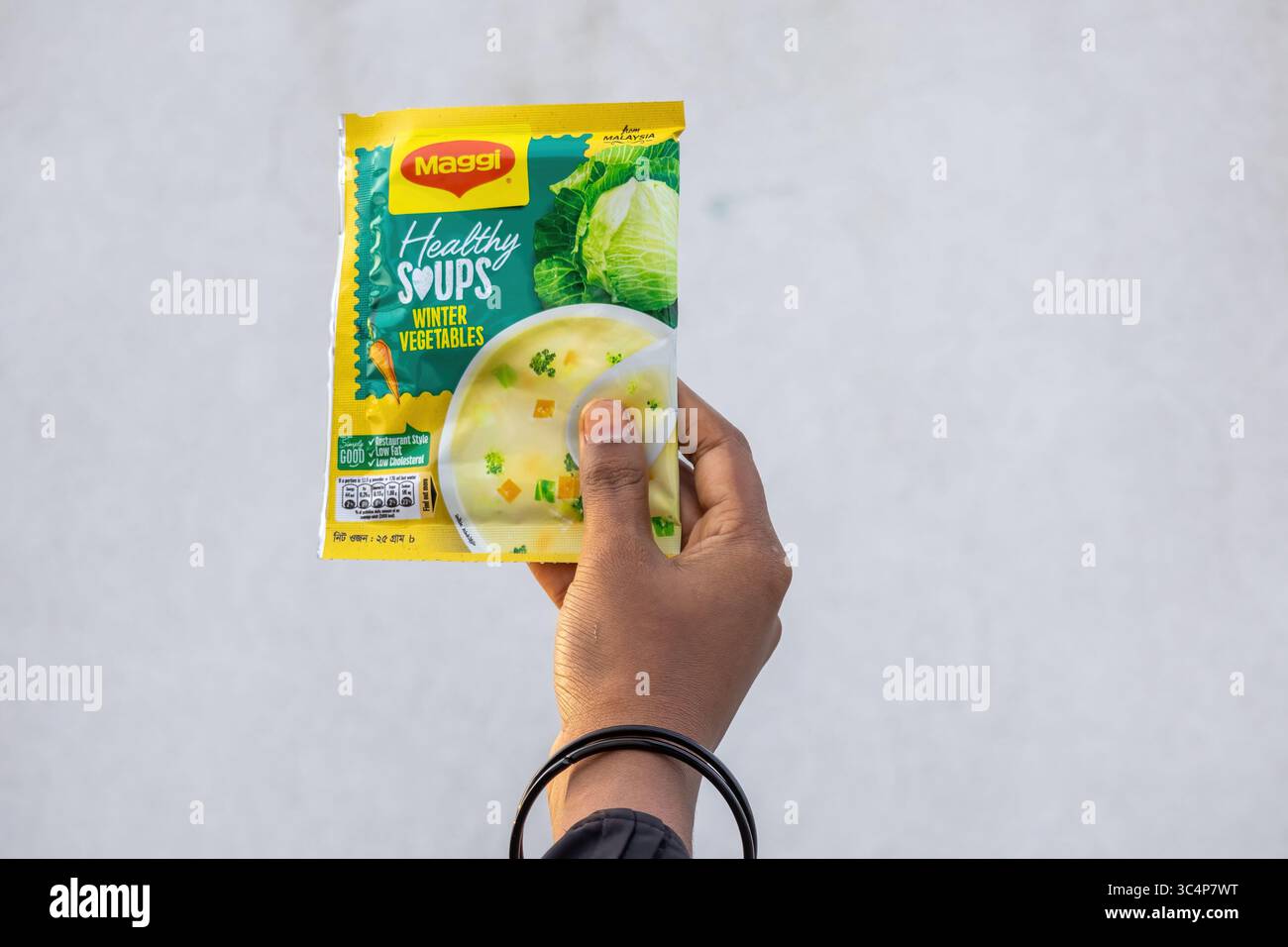 Female hand holding Maggi Healthy Soup, a 25g sachet of winter ...