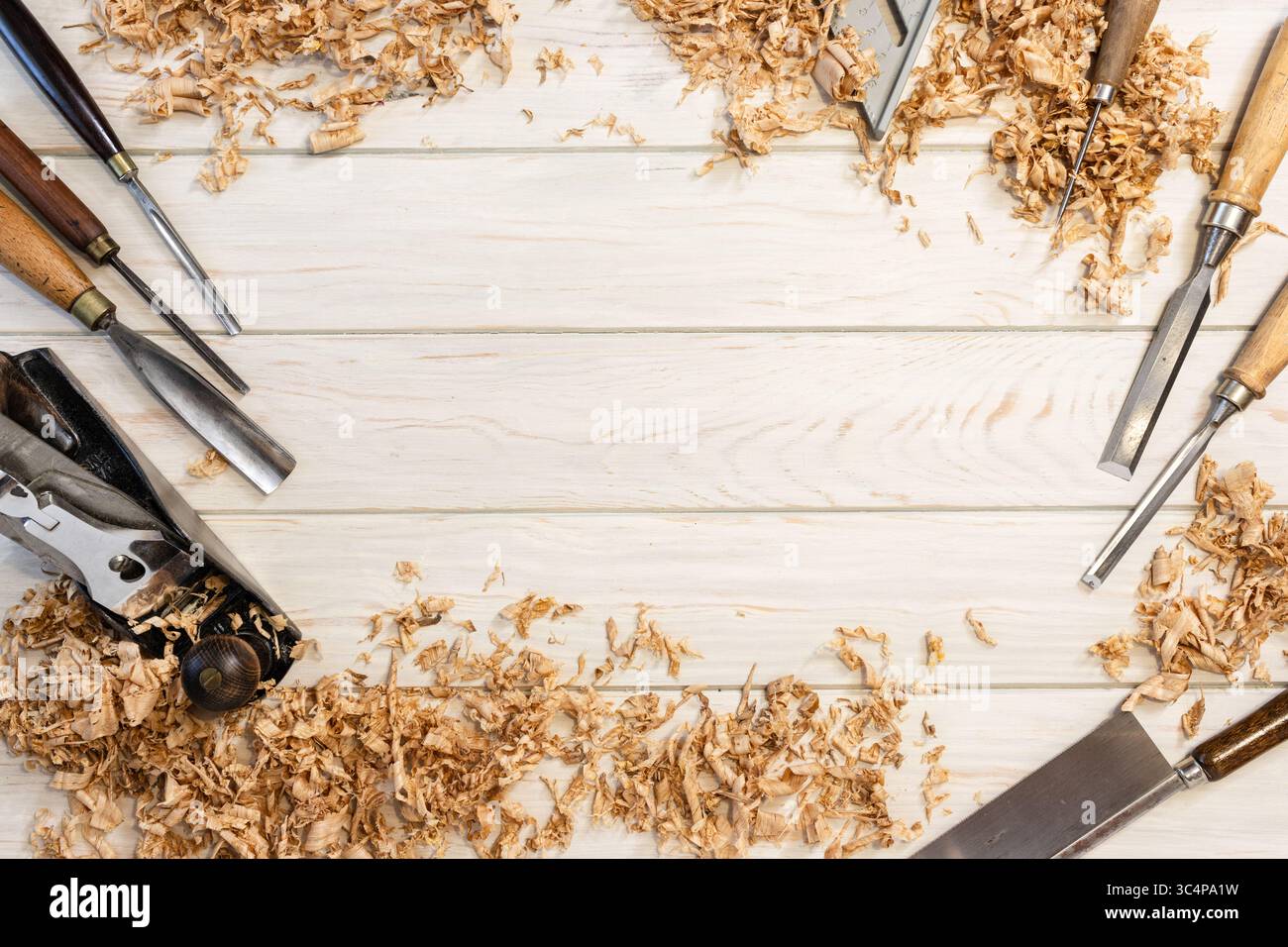 Flat lay of traditional carpenter tools and wood shavings on white ...