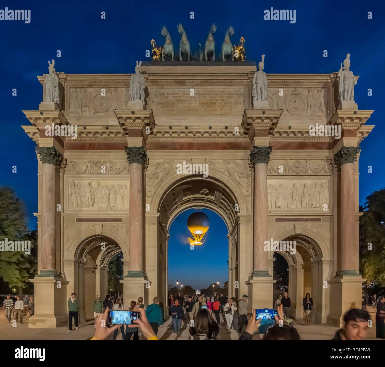 Paris, France - 07 28 2025: People standing are walking under Carrousel ...
