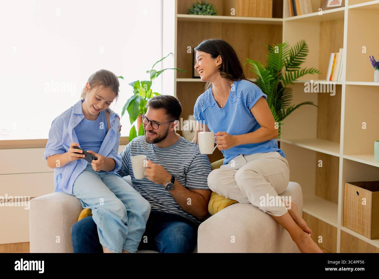Joyful family interaction unfolds hi-res stock photography and images ...