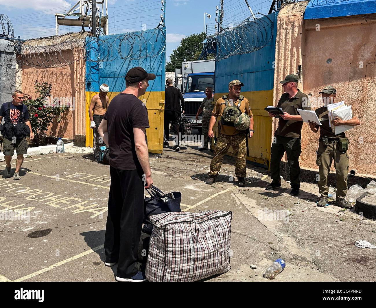 An inmate carries his belongings in a prison hit by a Russian strike in ...