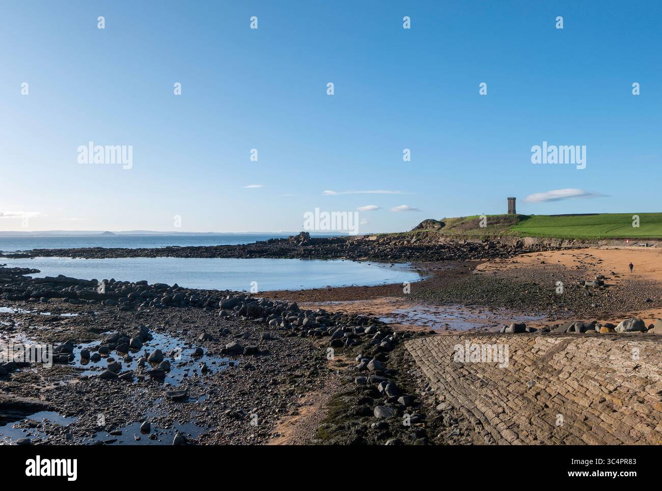 View over Billow Ness beach to the war monument on the hilltop from the ...