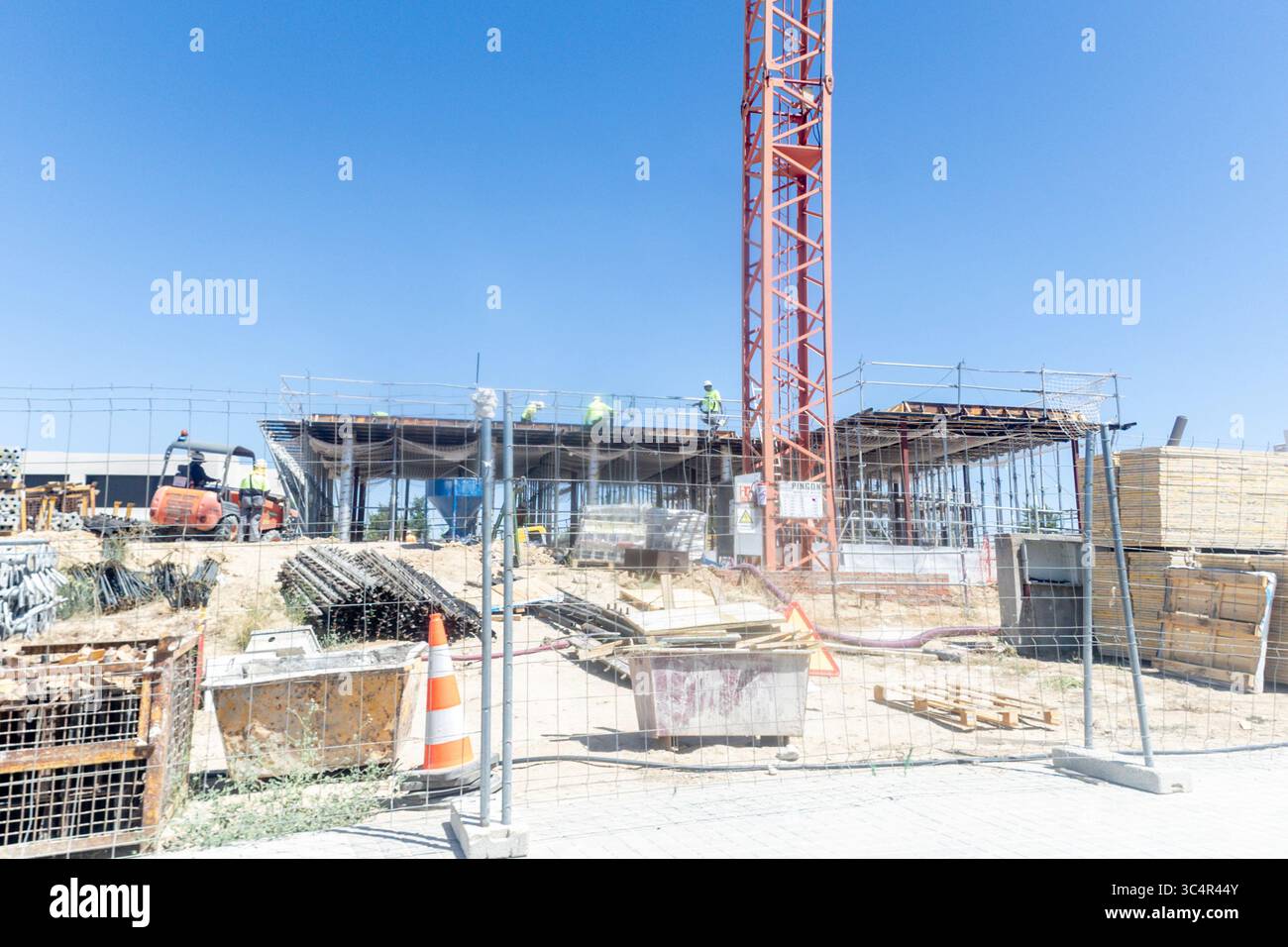 Workers work on the construction of a new home on July 29, 2025, in ...
