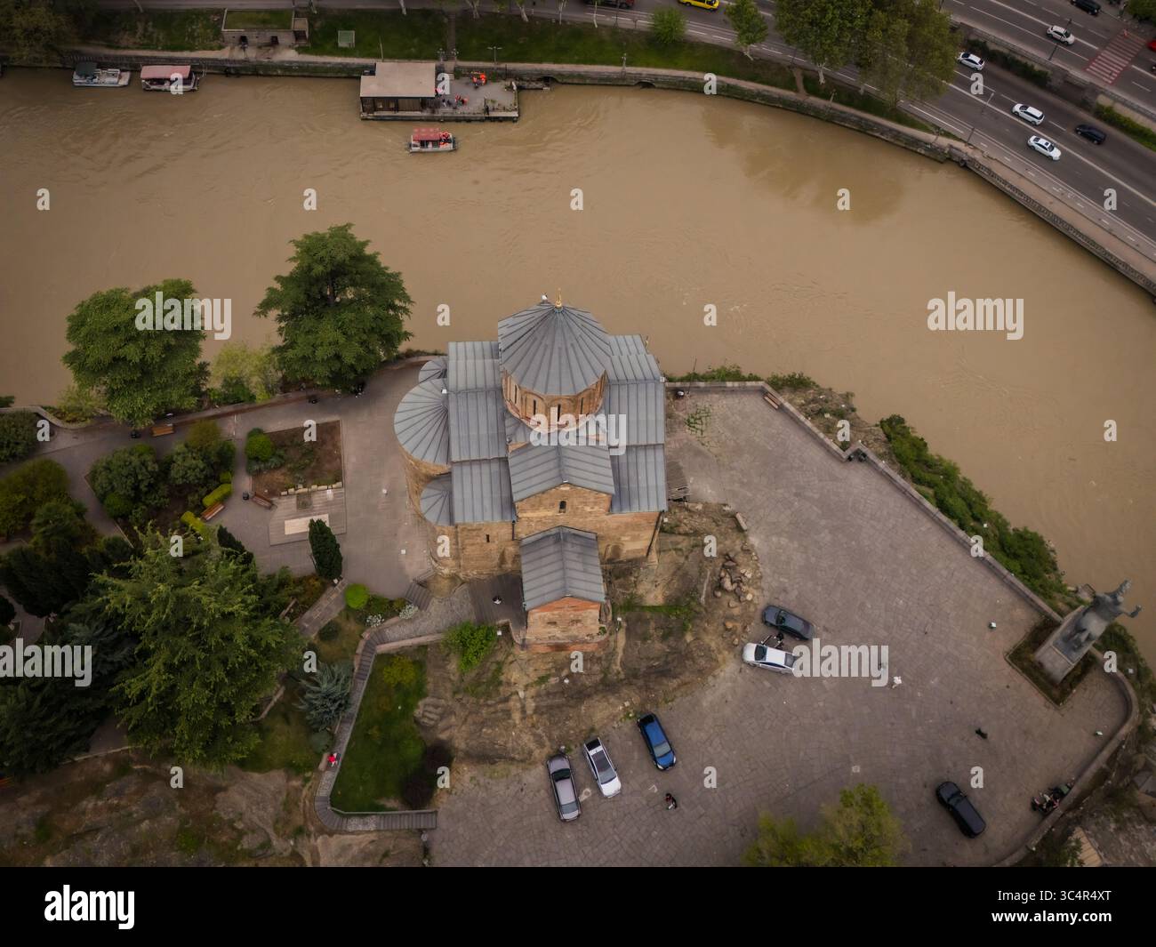 Aerial view of the Metekhi Church standing proudly on a cliff ...