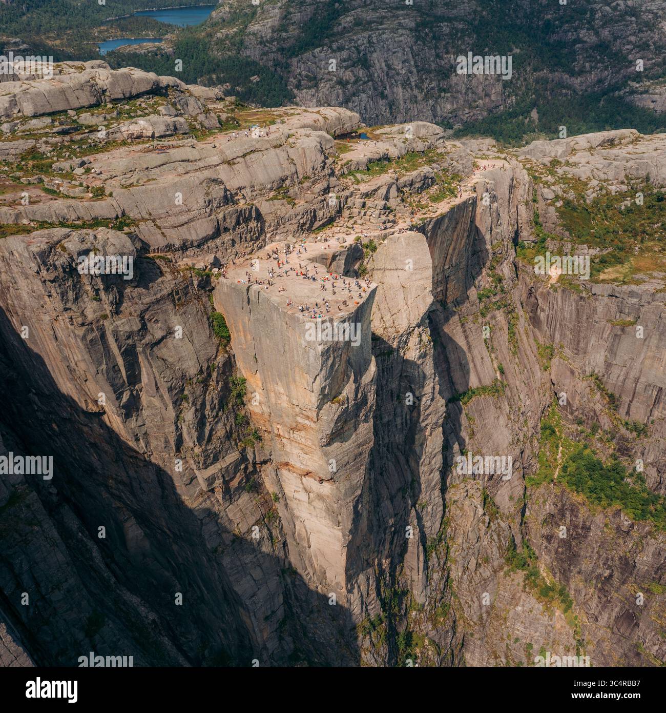 Aerial view of the iconic Preikestolen cliff dramatically jutting out ...