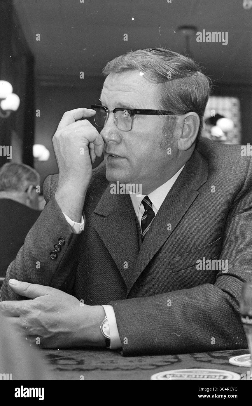 Man hand on chin table Black and White Stock Photos & Images - Alamy