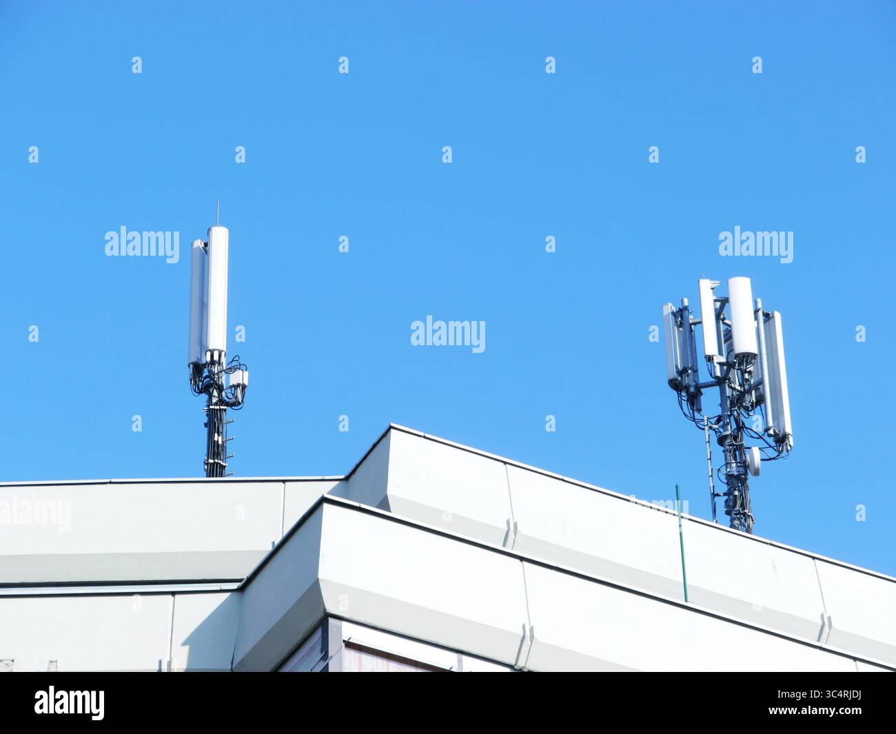 Two tall towers with antennas on top of a building Stock Photo - Alamy