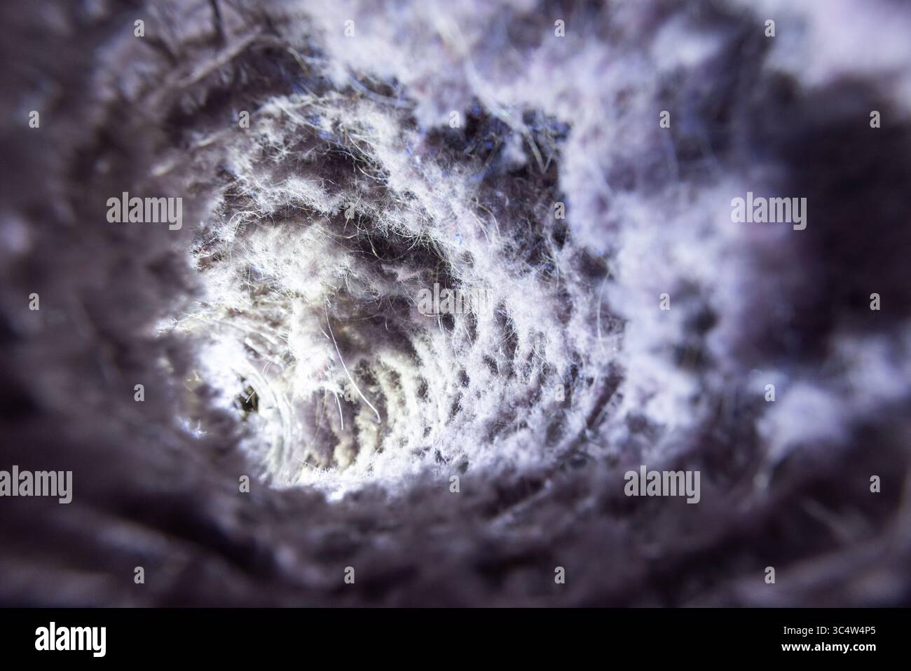 Close-up image of lint buildup inside a dryer vent, highlighting a ...