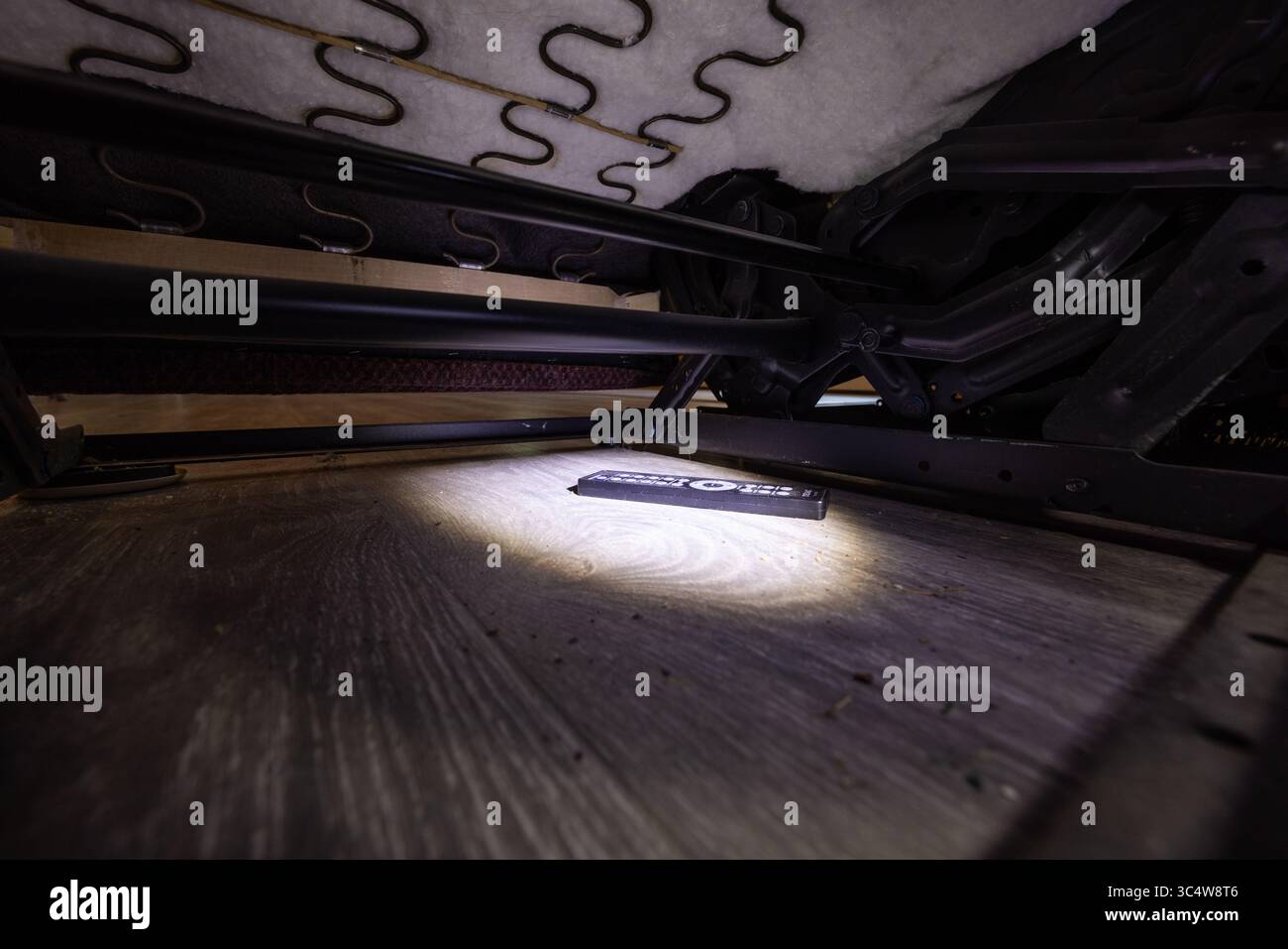Realistic home scene of a person using a flashlight to search for a ...