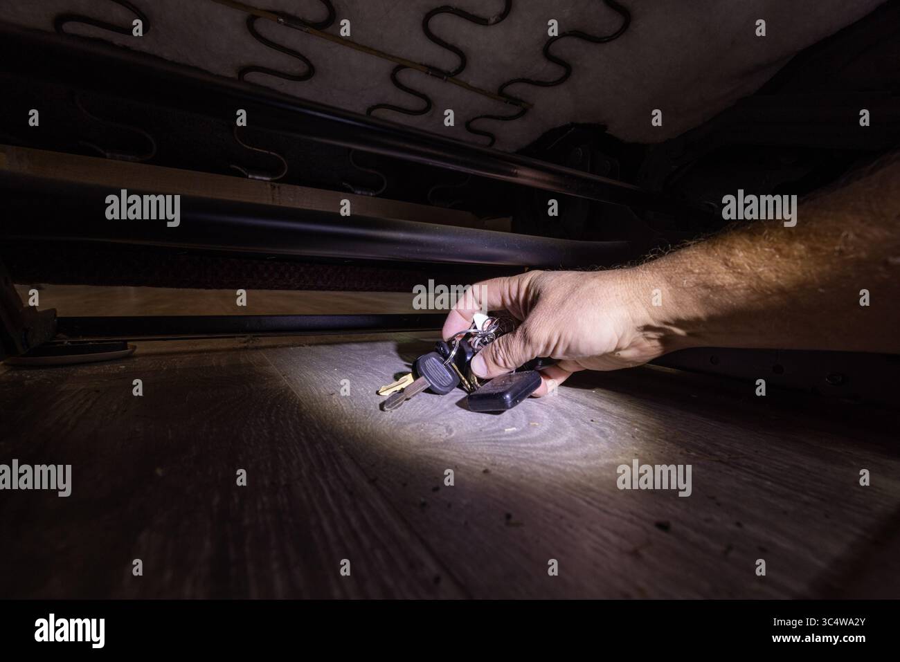 Person uses flashlight search beneath hi-res stock photography and ...